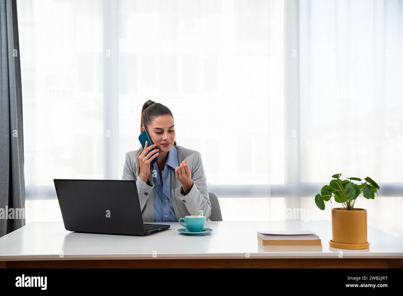 Young businesswoman adjusting to her new workplace after being promoted ...