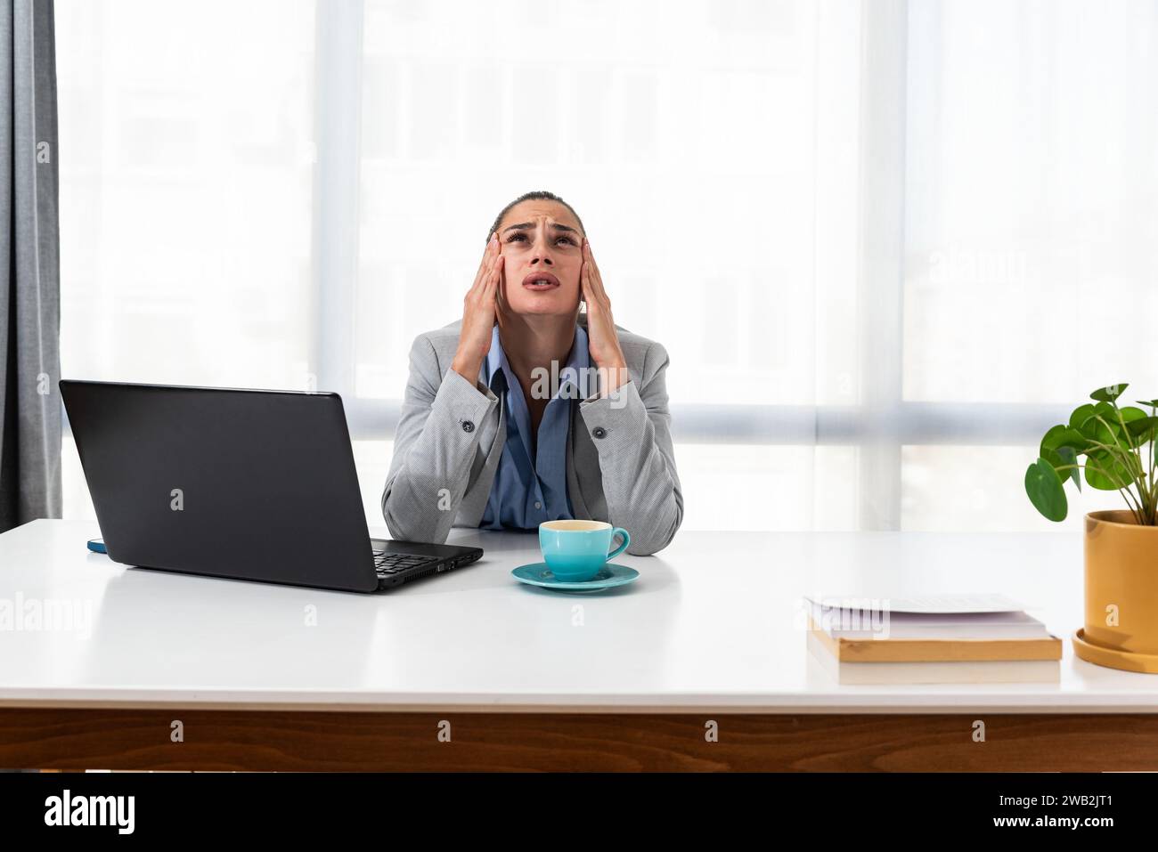 Young businesswoman adjusting to her new workplace after being promoted ...