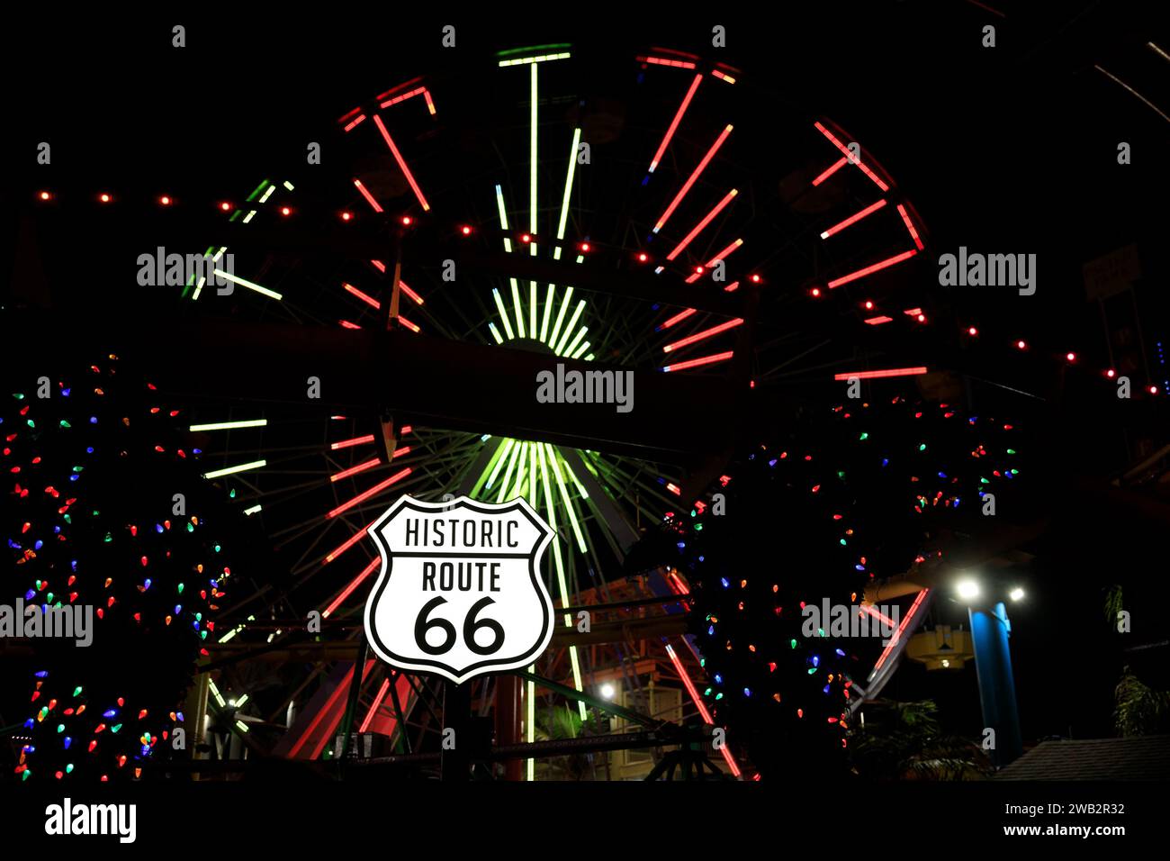 Night shot of the famous Route 66 sign in front of the Ferris wheel ...