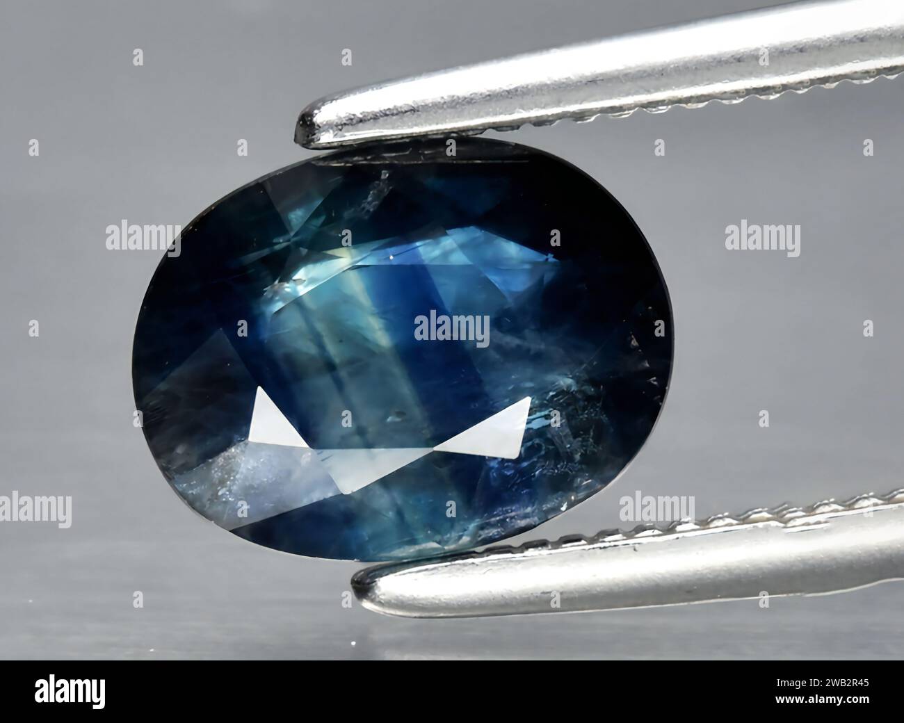 Natural dark blue sapphire gem on background Stock Photo - Alamy