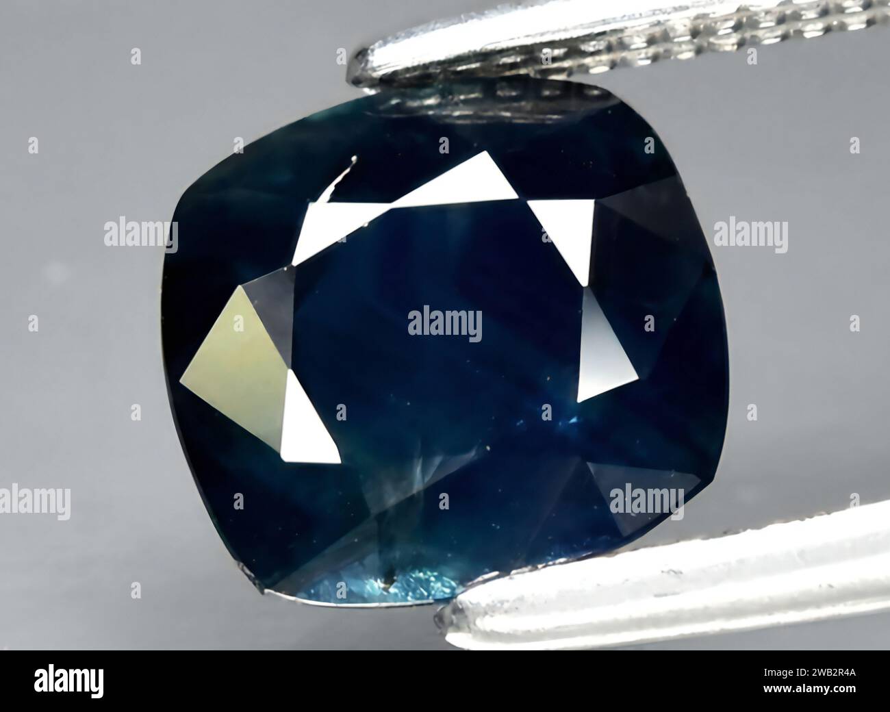 Natural dark blue sapphire gem on background Stock Photo - Alamy