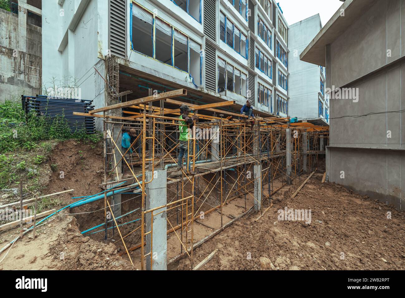 Construction workers working building at construction site. Scaffolding ...
