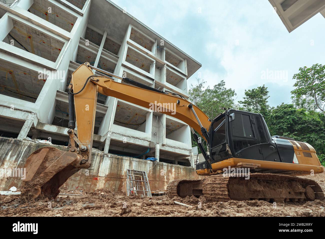 excavator working at construction site, backhoe on building site. wide ...