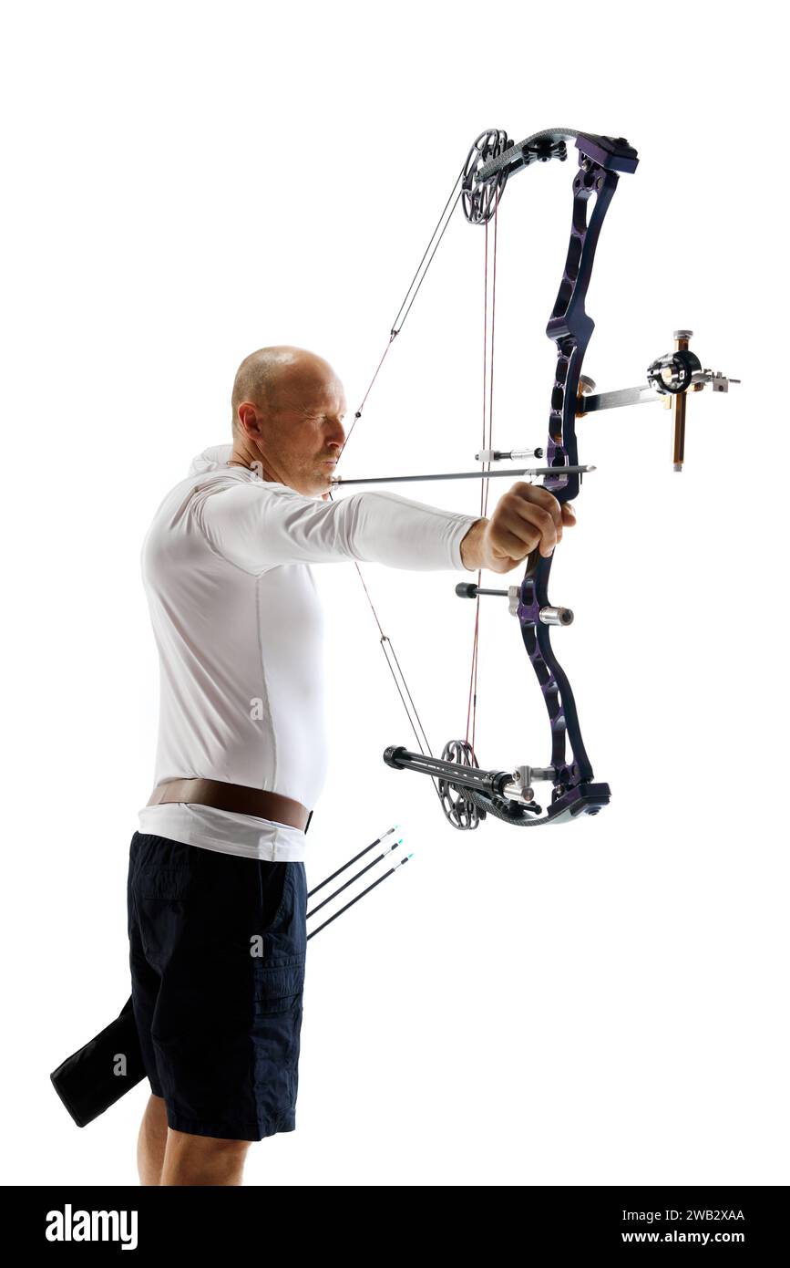Full-length of serious man, archery sportsman aiming archery bow on ...