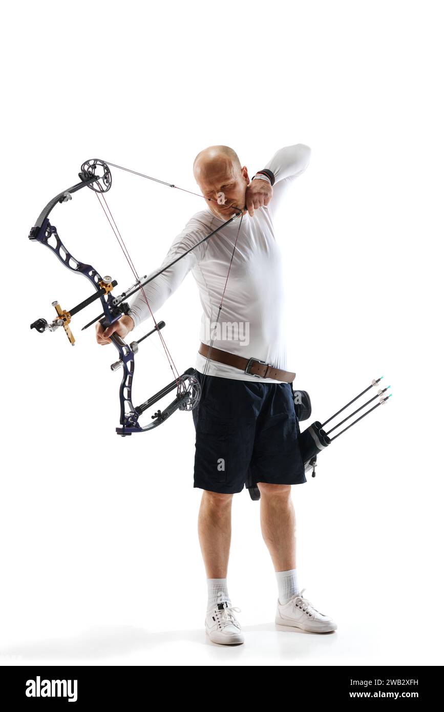Concentrated man, archery athlete with special equipment training ...