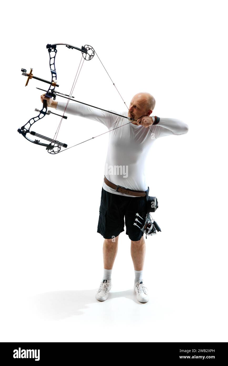 Man, professional archer training, aiming archery bow into target ...