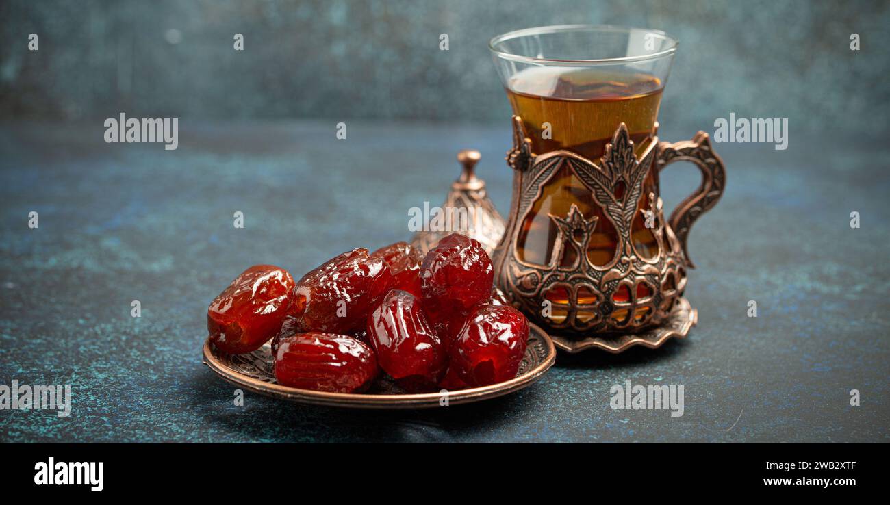 Breaking fasting with dried dates during Ramadan Kareem, Iftar meal ...