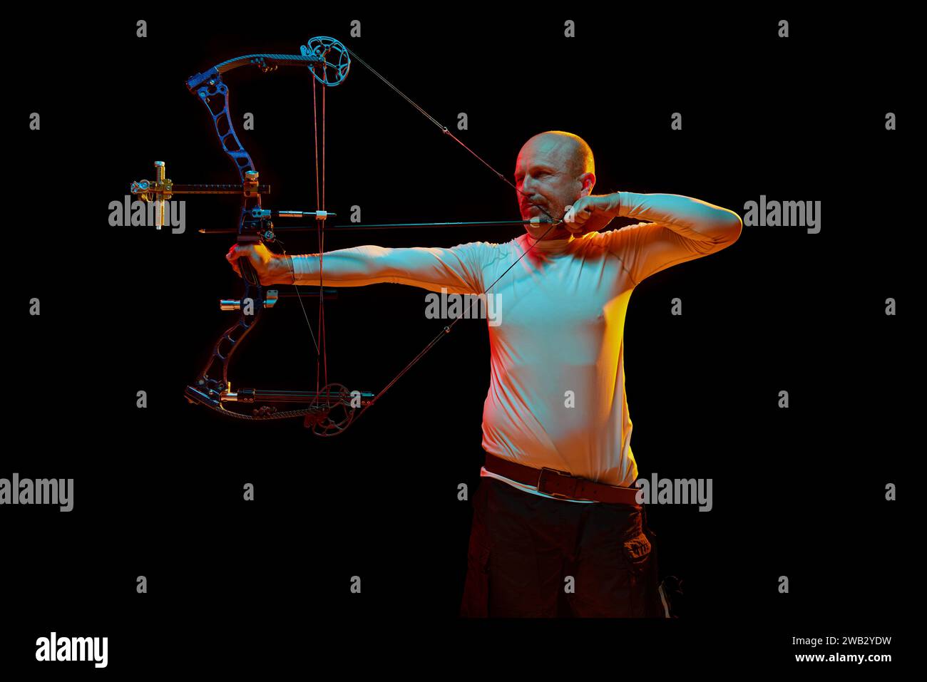 Man, professional archer training, aiming archery bow into target ...
