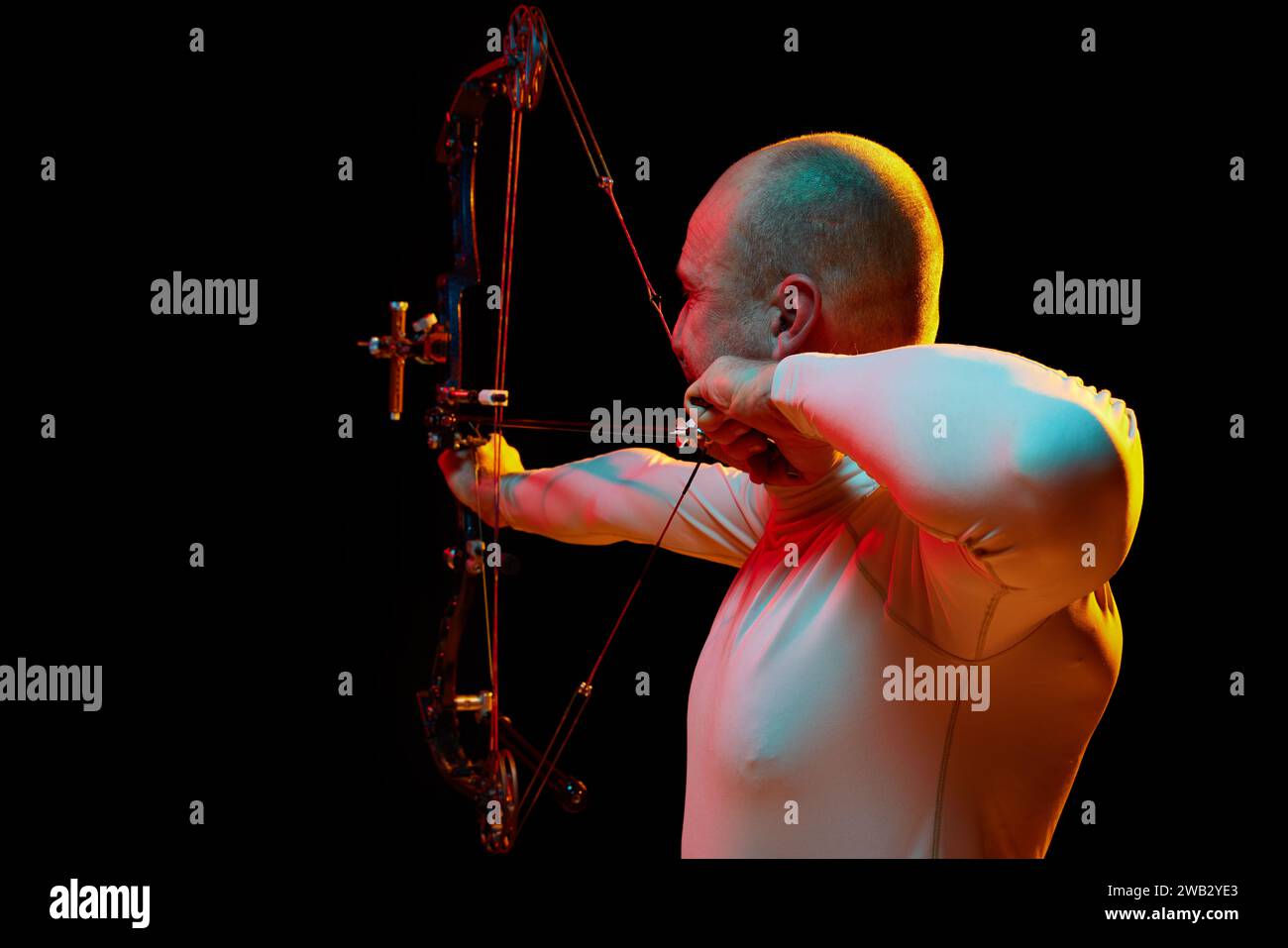 Back view image of man, archery at hele aiming with archery bow on ...