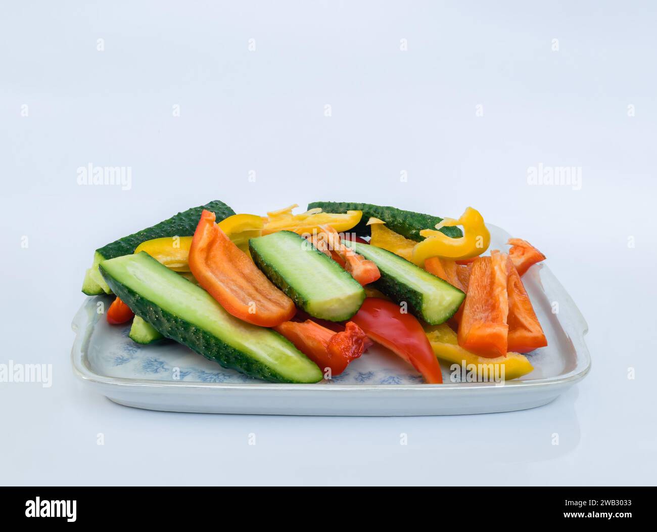 Vegetable slices of yellow and red peppers and cucumbers on a square ...