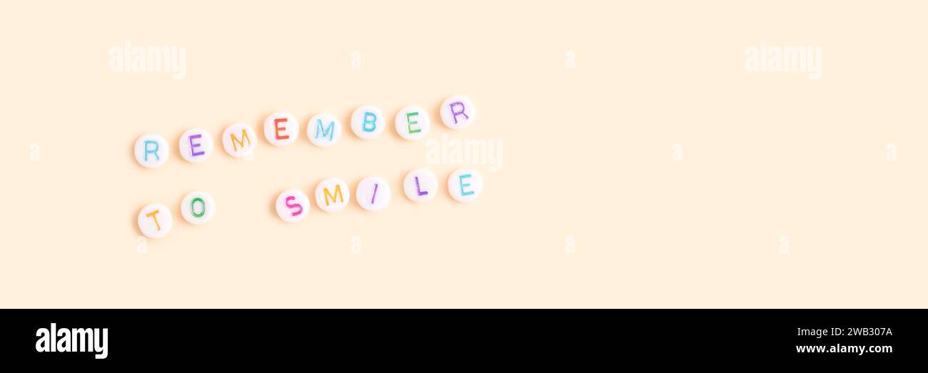 Remember to smile. Banner with quote made of beads with letters on a ...