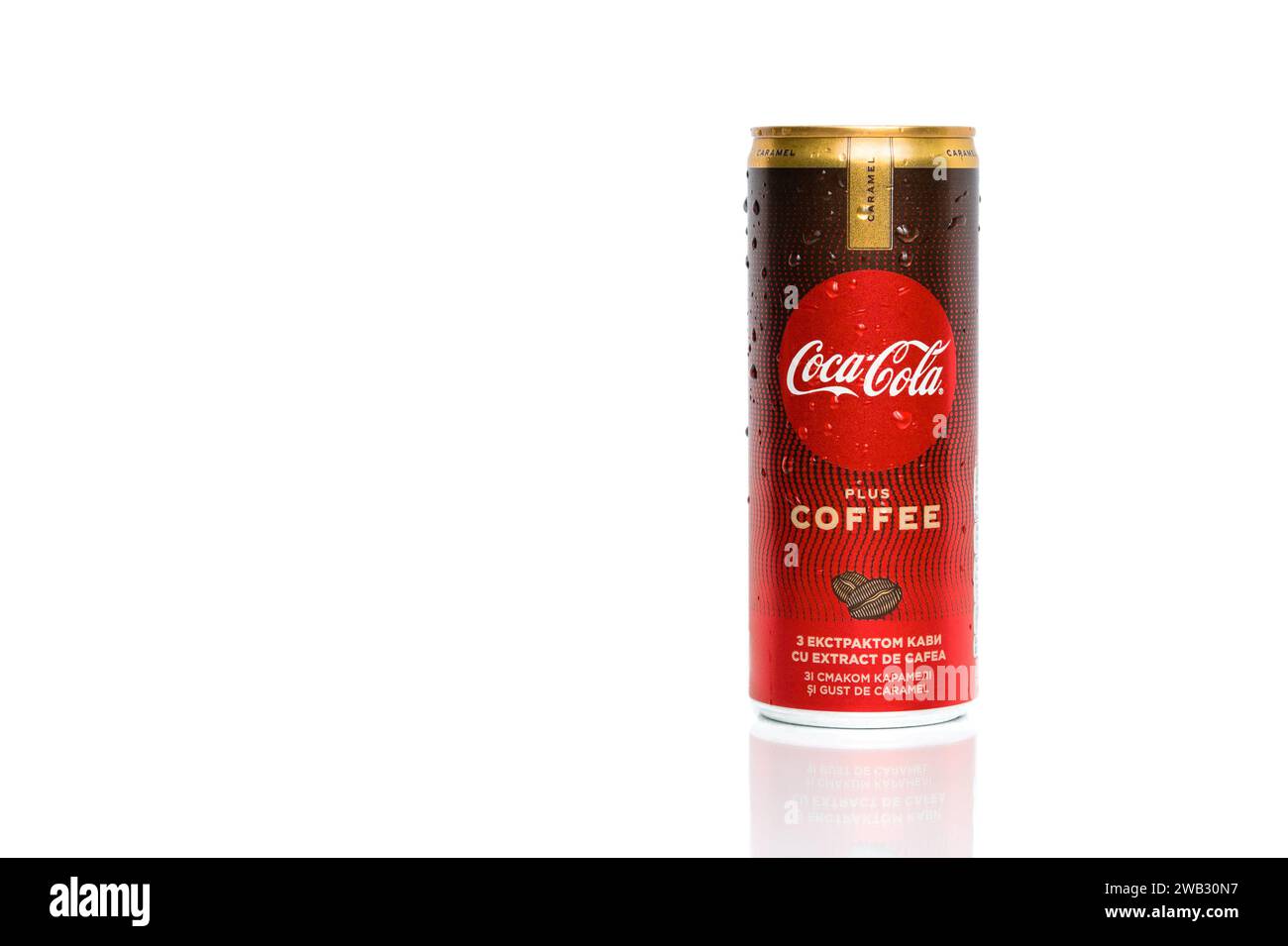 A can of Coca-Cola Plus Coffee Caramel with drops of water on a white ...