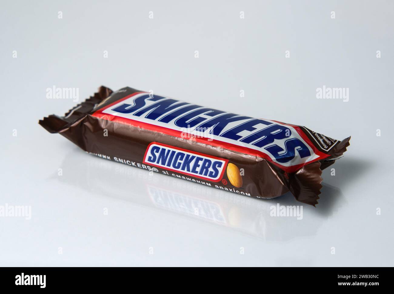 Snickers chocolate bar isolated on white background with reflection ...
