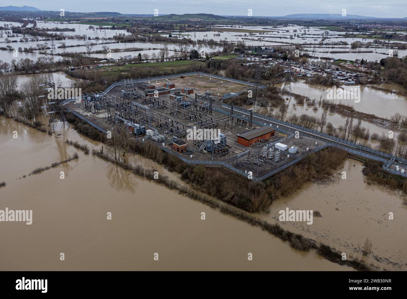 Flood water surrounds a power grid sub-station in Gloucester as fields ...