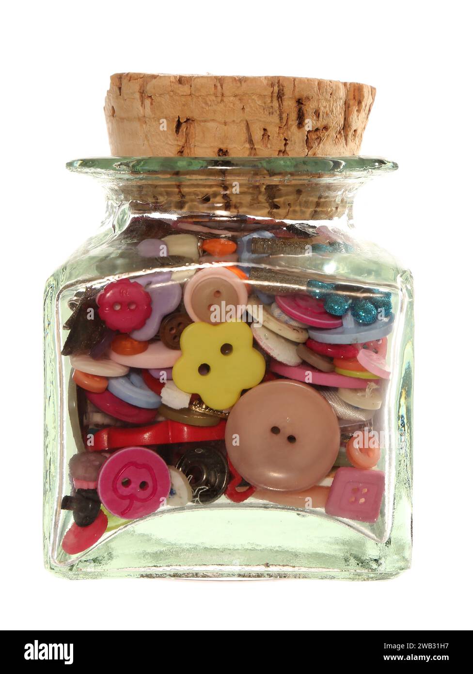 Glass jar with mixture of buttons for sewing isolated on a white ...