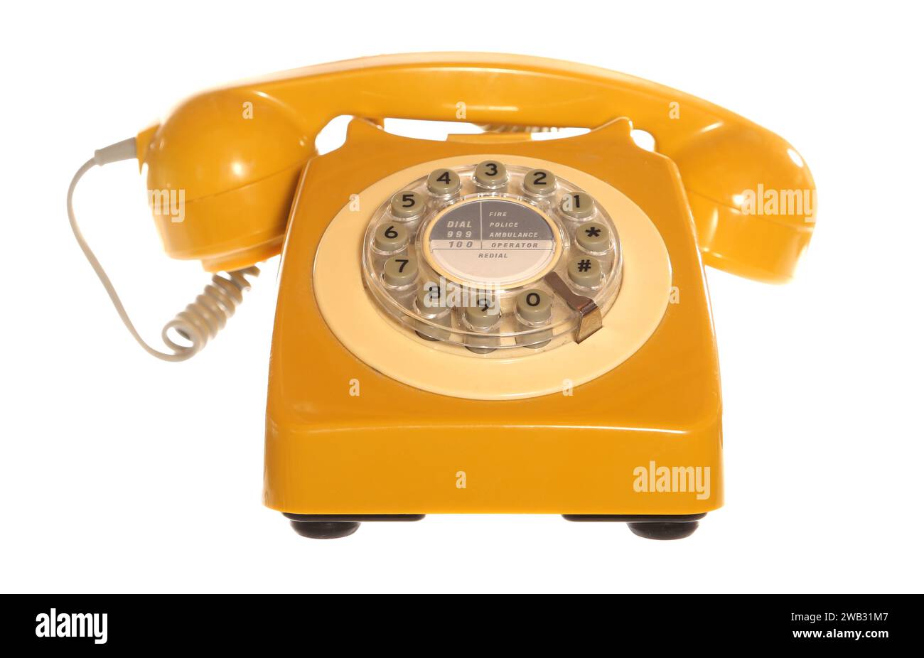 Yellow retro rotary corded telephone isolated on a white background ...