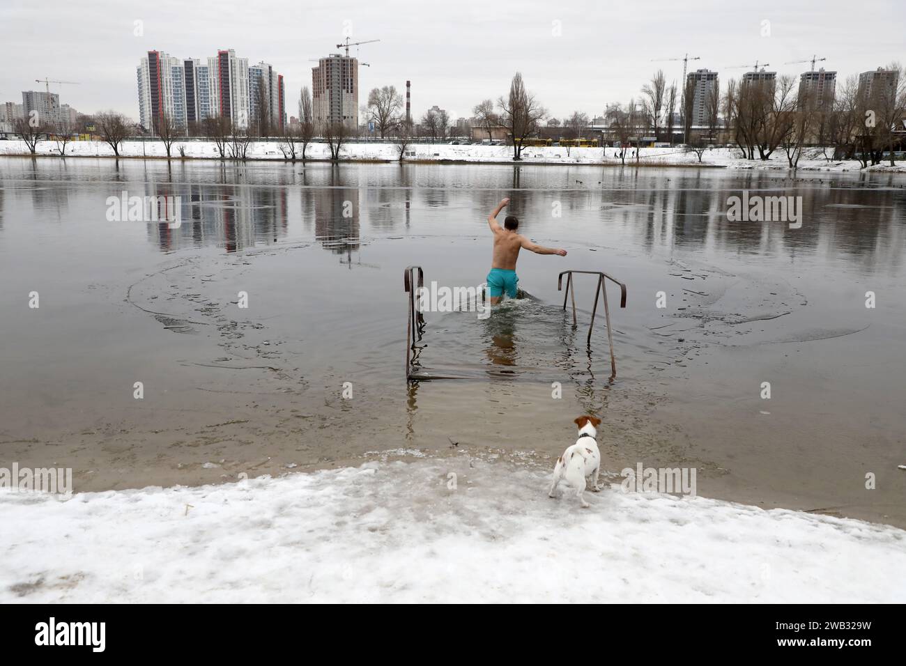 KYIV, UKRAINE - JANUARY 6, 2024 - A man walks into Lake Telbin on ...