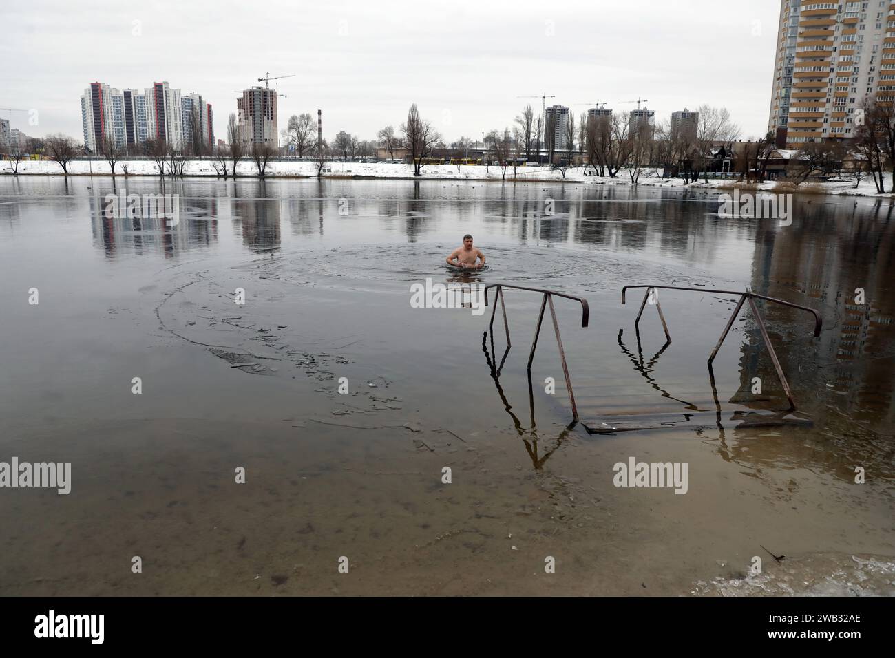 KYIV, UKRAINE - JANUARY 6, 2024 - A man bathes in Lake Telbin on ...