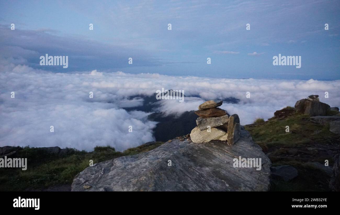 A stack of rocks on a large boulder in a mountainous area. Chandrashila ...