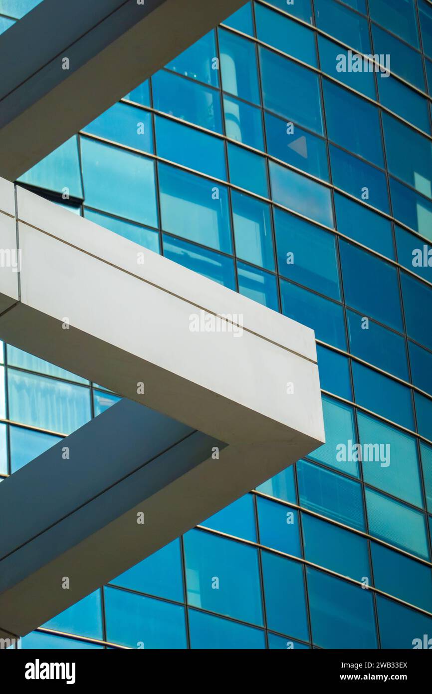 Abstract close-up of a modern glass building with reflective windows ...