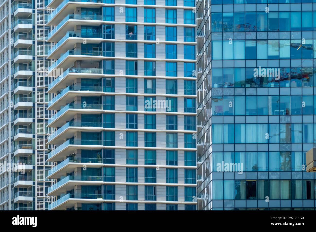 Modern high-rise apartment buildings with glass facades and balconies ...