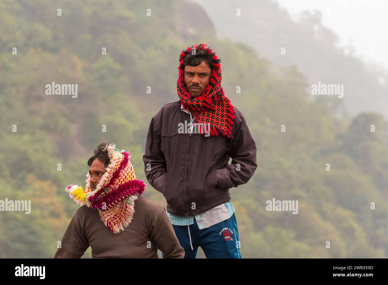 A portrait of two Indian men protecting themselves from the elements in ...