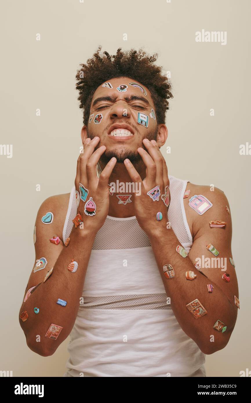 emotional african american man with stickers on face scratching beard ...