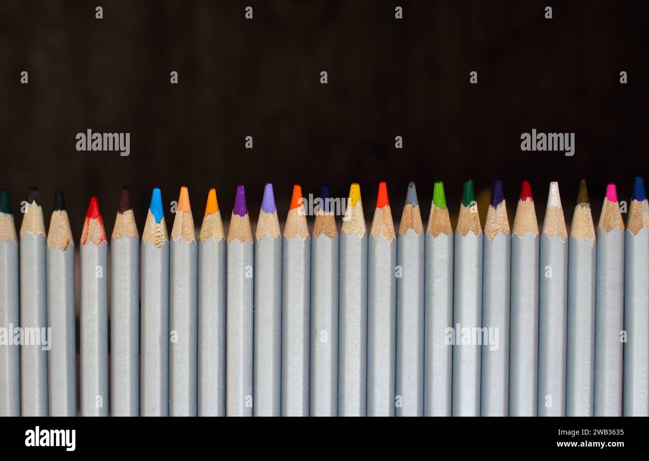 Colourful pencils in a row. Bright pencils on black background. Drawing ... Colourful pencils in a row. Bright pencils on black background. Drawing ...