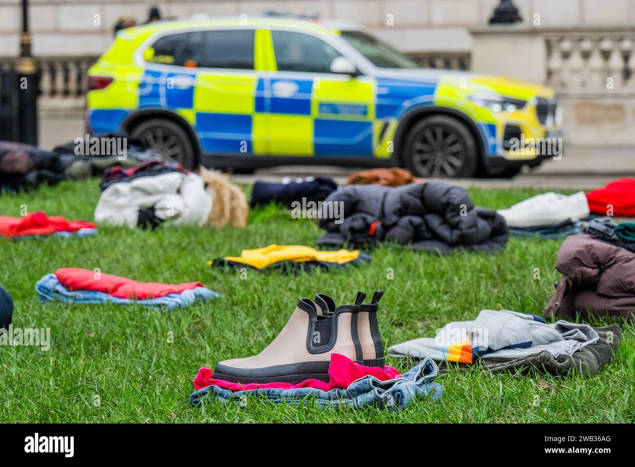 London, UK. 8th Jan, 2024. Police vehicles including armed units pass ...
