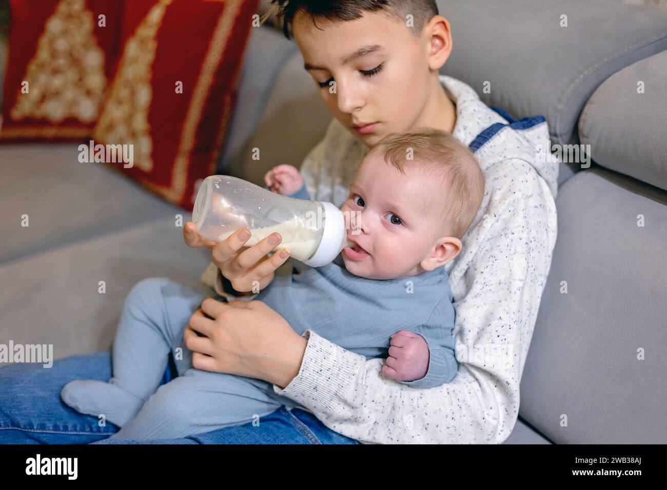 Happy family, newborn baby and older brothers, mom at home on Christmas ...
