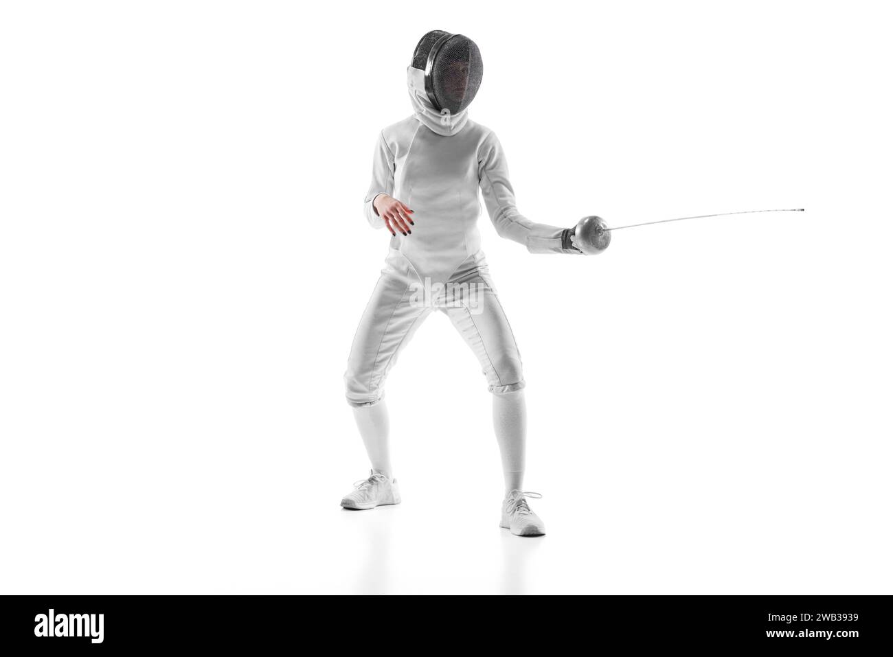Female fencer intense gaze as she anticipates her opponent's move ...