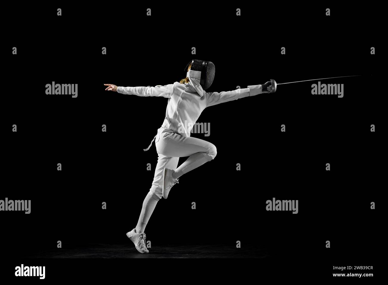 Confidence and strength. Female athlete in fencing gear showcasing her ...