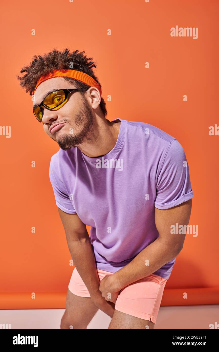 funny african american man in eyeglasses and headband pouting lips on ...