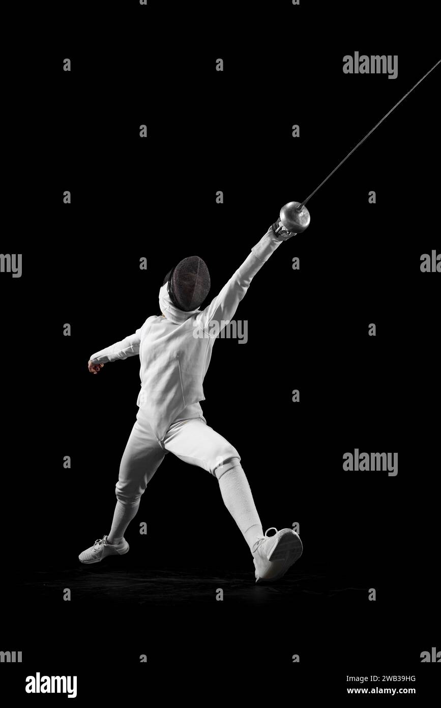 Dynamic portrait of female fencer lunges forward, her blade poised to ...