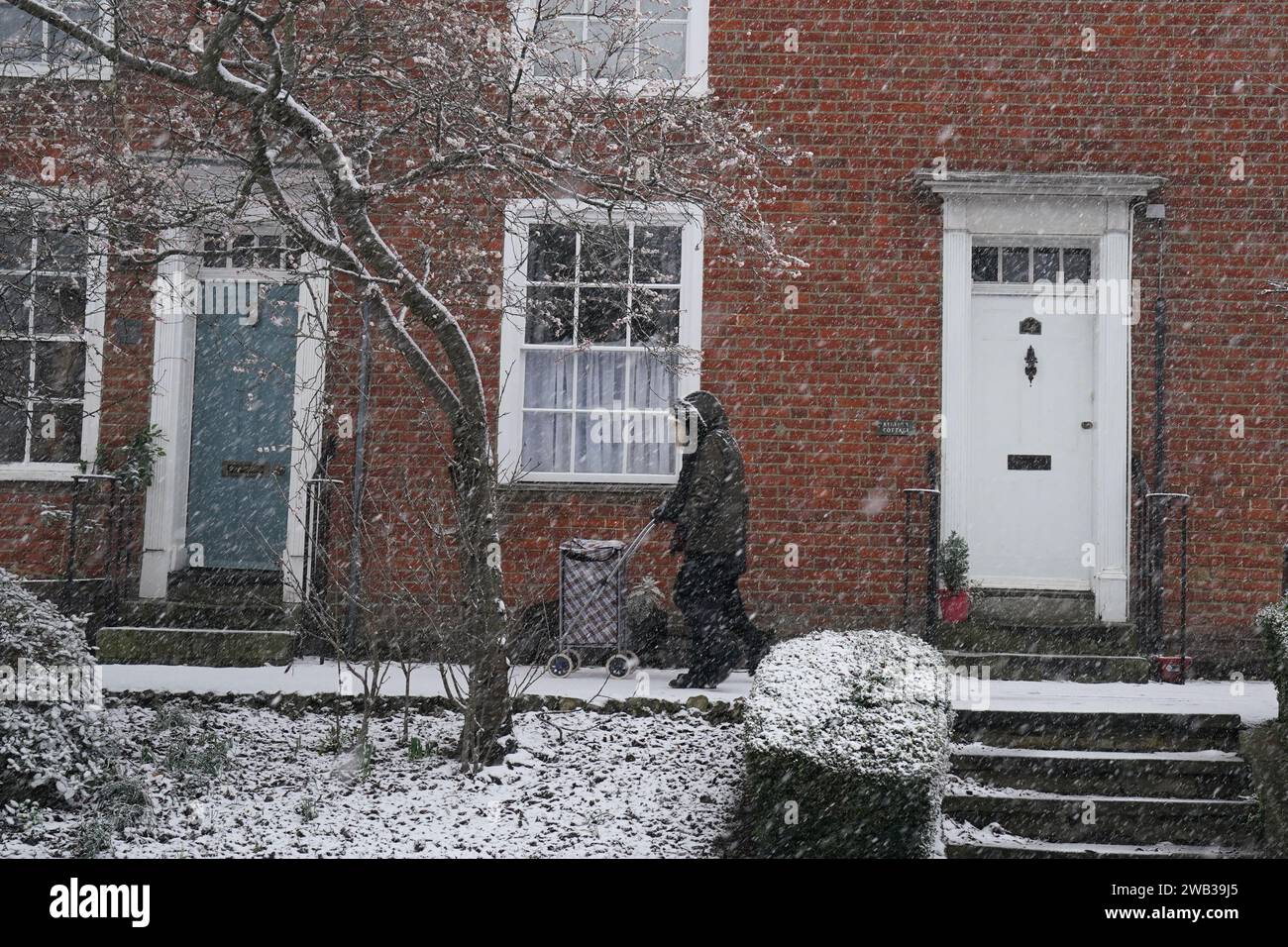 People walking through a snow flurry in Lenham, Kent. Sleet and snow ...