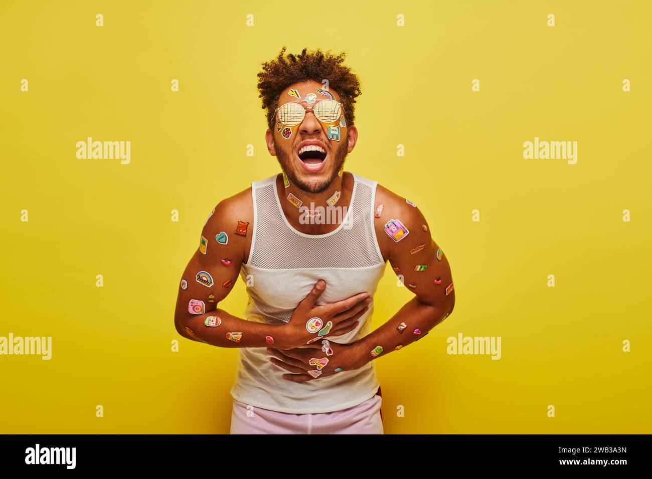 excited african american man with stickers on his face and body ...