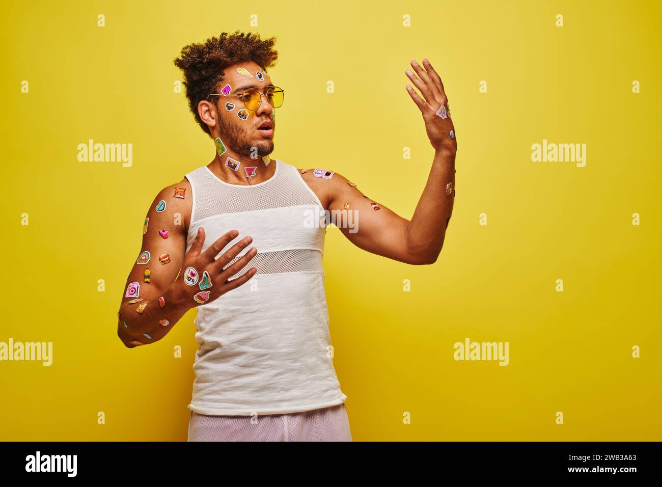 surprised african american man looking at stickers on his hands and ...