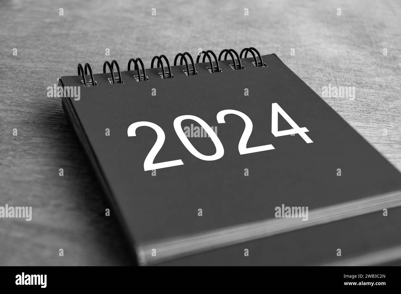 Black and white Year 2024 desk calendar on wooden desk. New Year and ...