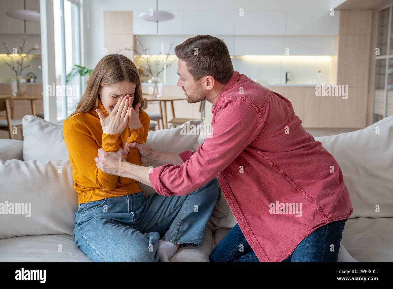 Rude male aggressor shouting at crying terrified female victim ...
