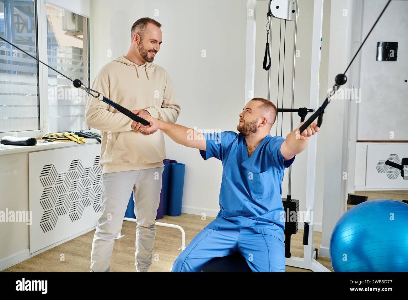 doctor in blue uniform showing exercise on training machine to smiling ...