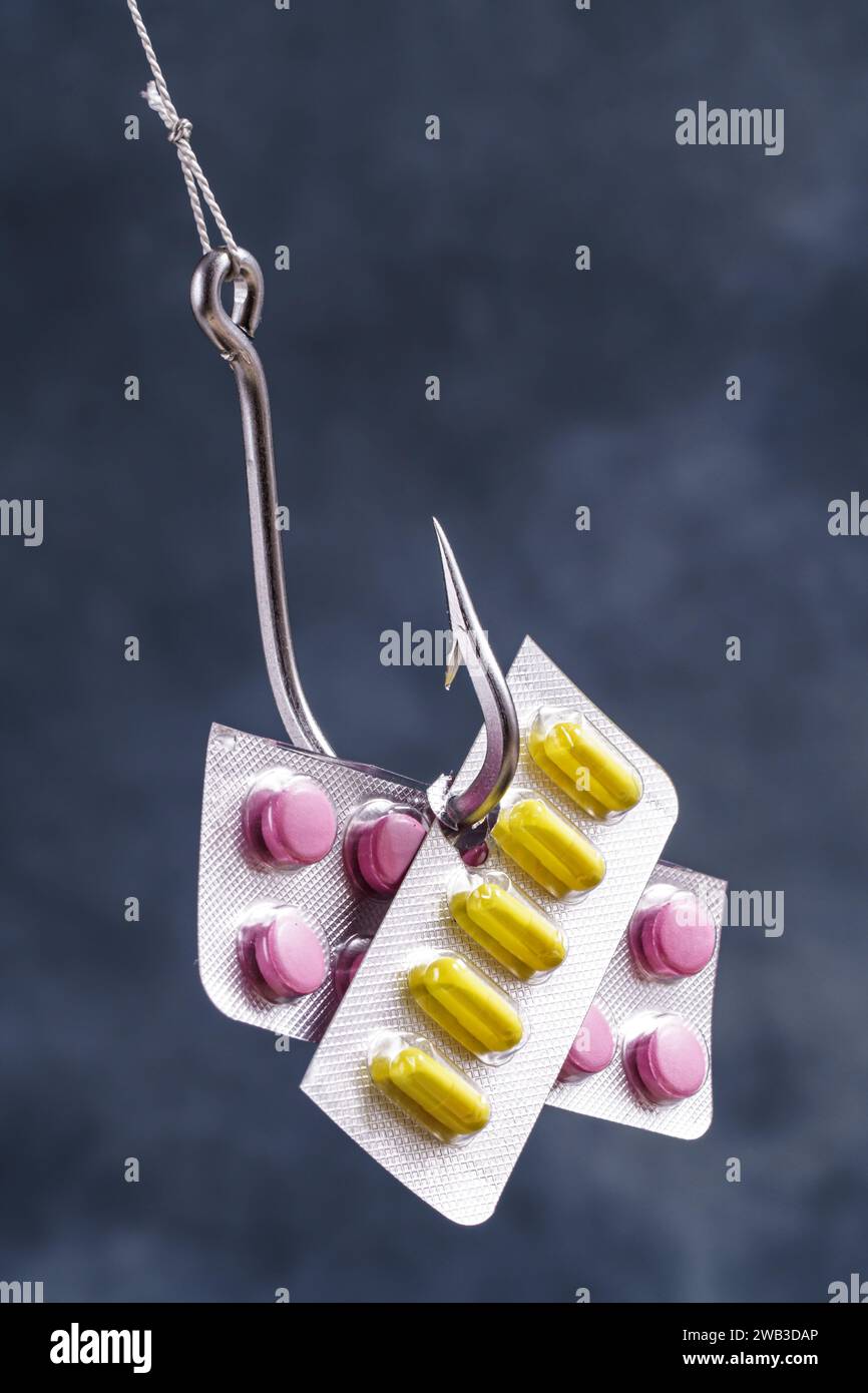 Pill bait. Tablet blisters on a fishing hook. The concept of medication ...