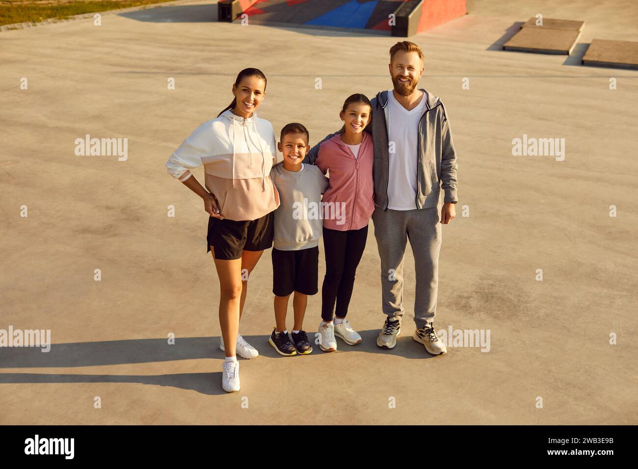 Happy smiling sporty family with children looking cheerful at camera ...