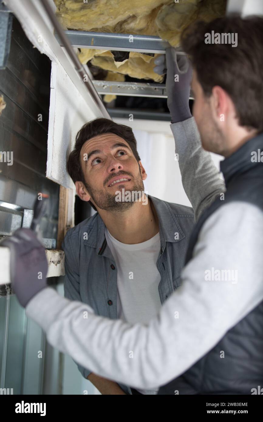 electrician workers checking the ceiling Stock Photo - Alamy