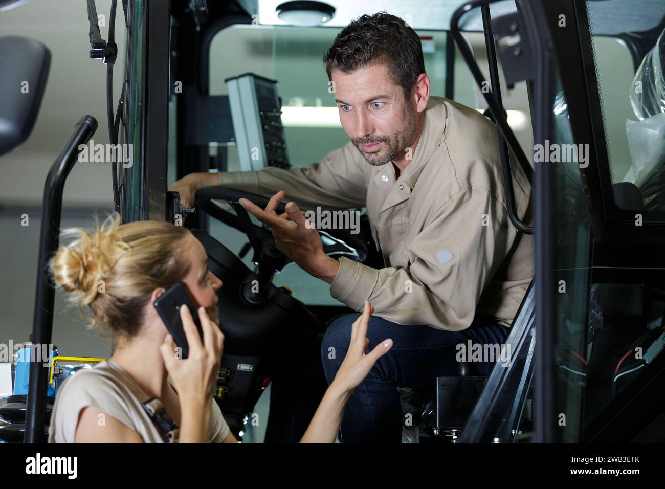 female supervisor gives work assignment to forklift driver Stock Photo ...