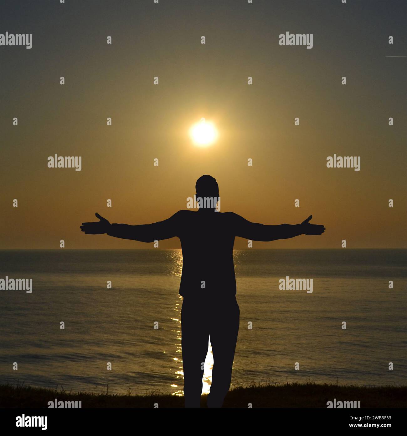 Silhouette of man enjoying freedom with open hands on sea Stock Photo ...