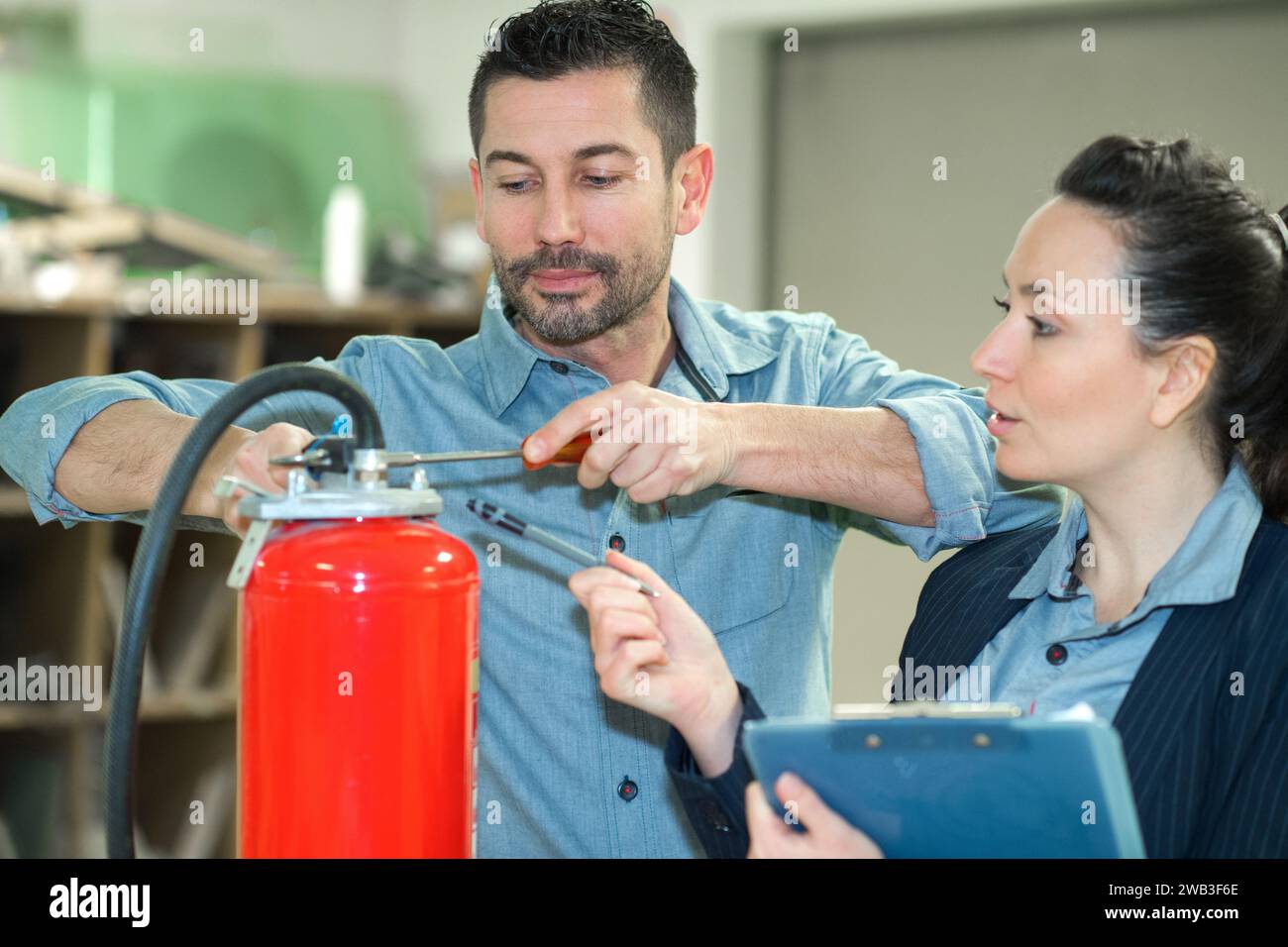 Checking fire extinguisher hi-res stock photography and images - Alamy