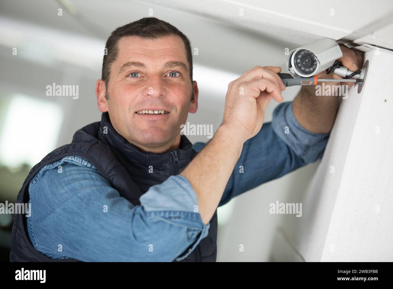 Security surveillance technician adjusting cctv hi-res stock ...