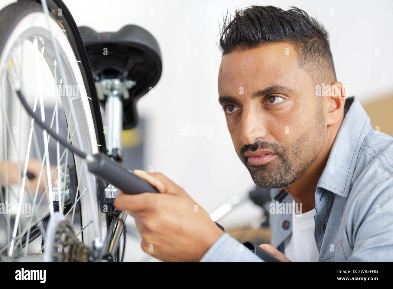 a man inflating bicycle tires Stock Photo - Alamy