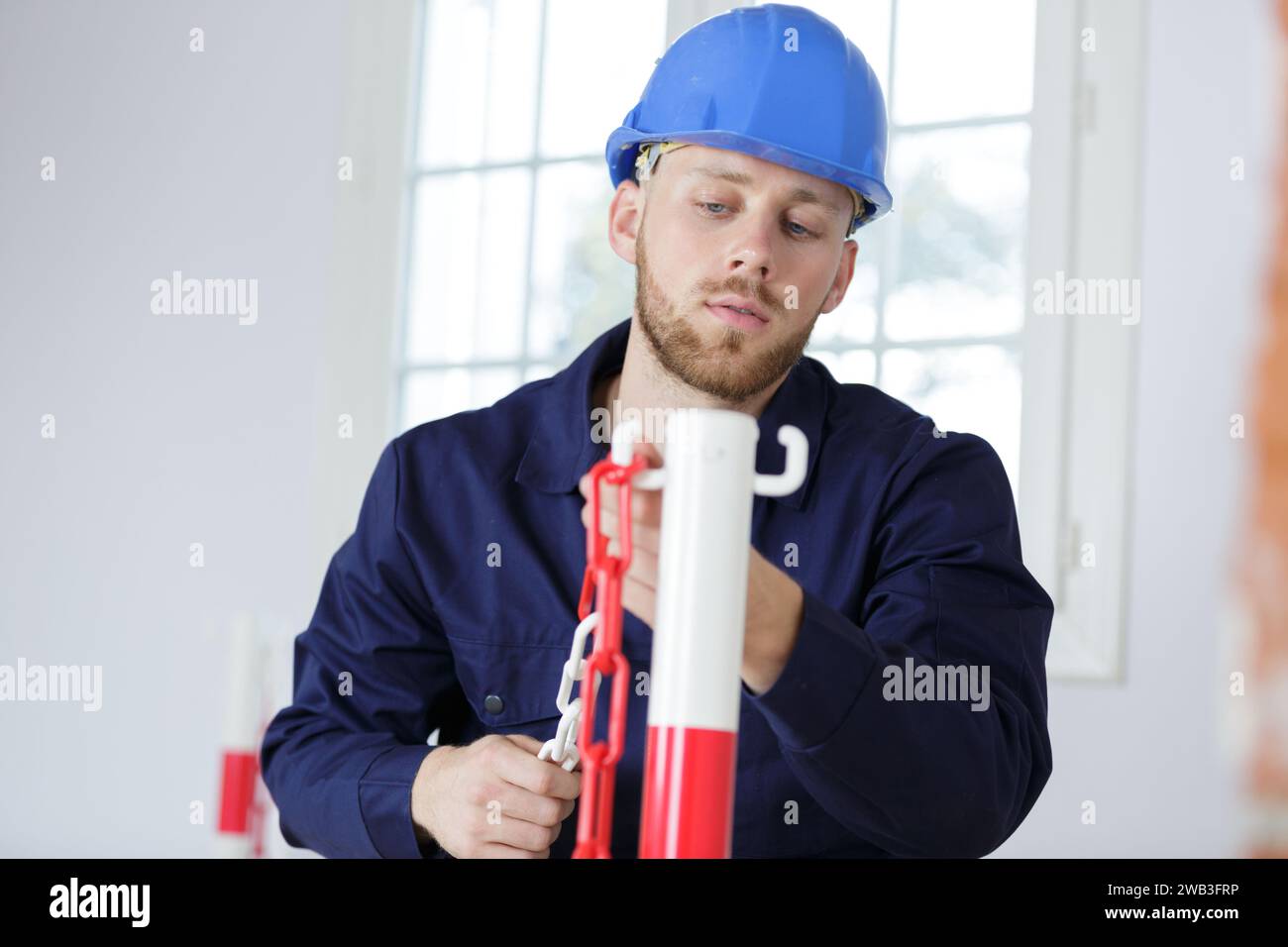 a man builder is fixing chains Stock Photo - Alamy