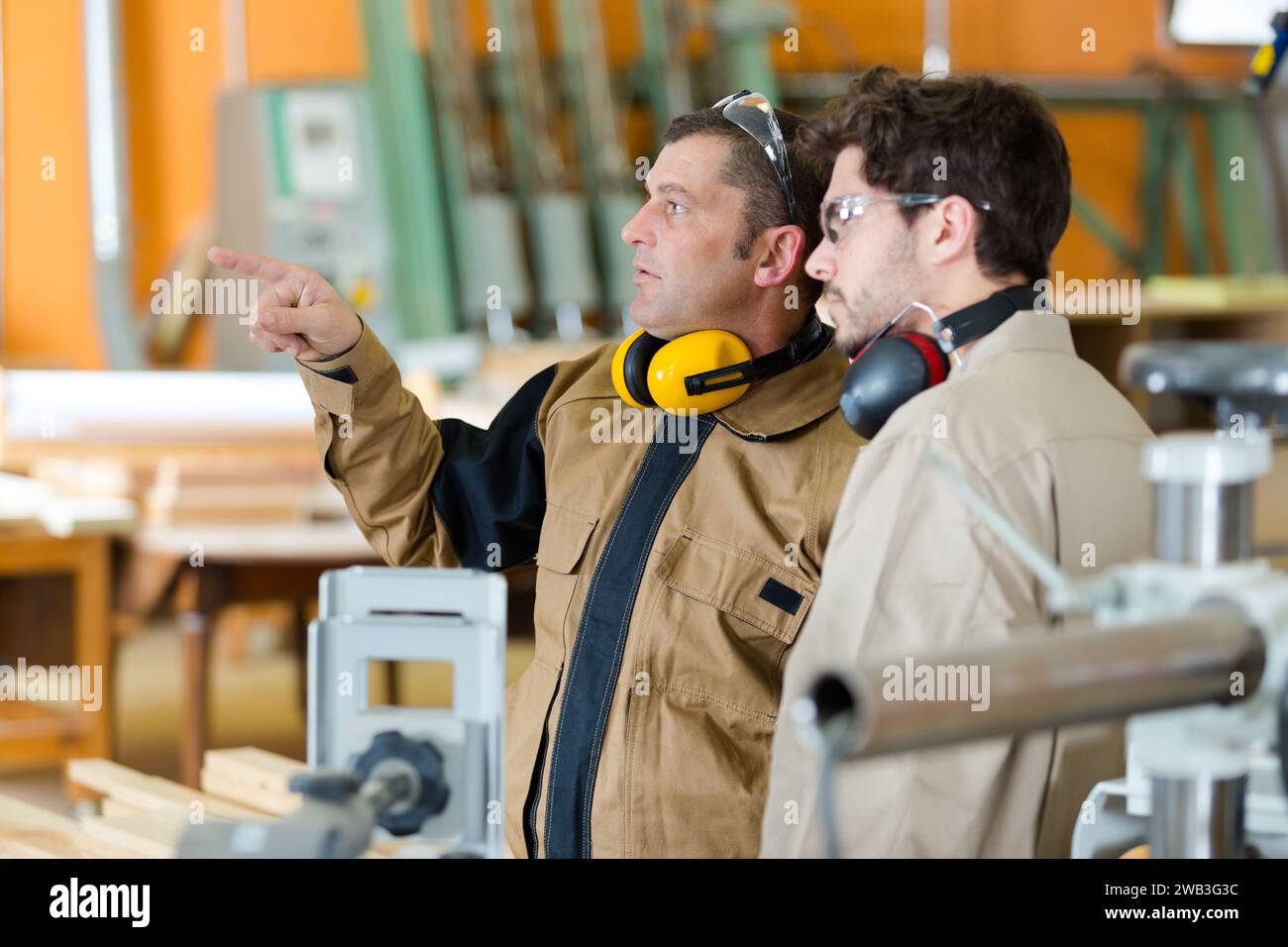 supervisor pointing at important job for worker Stock Photo - Alamy